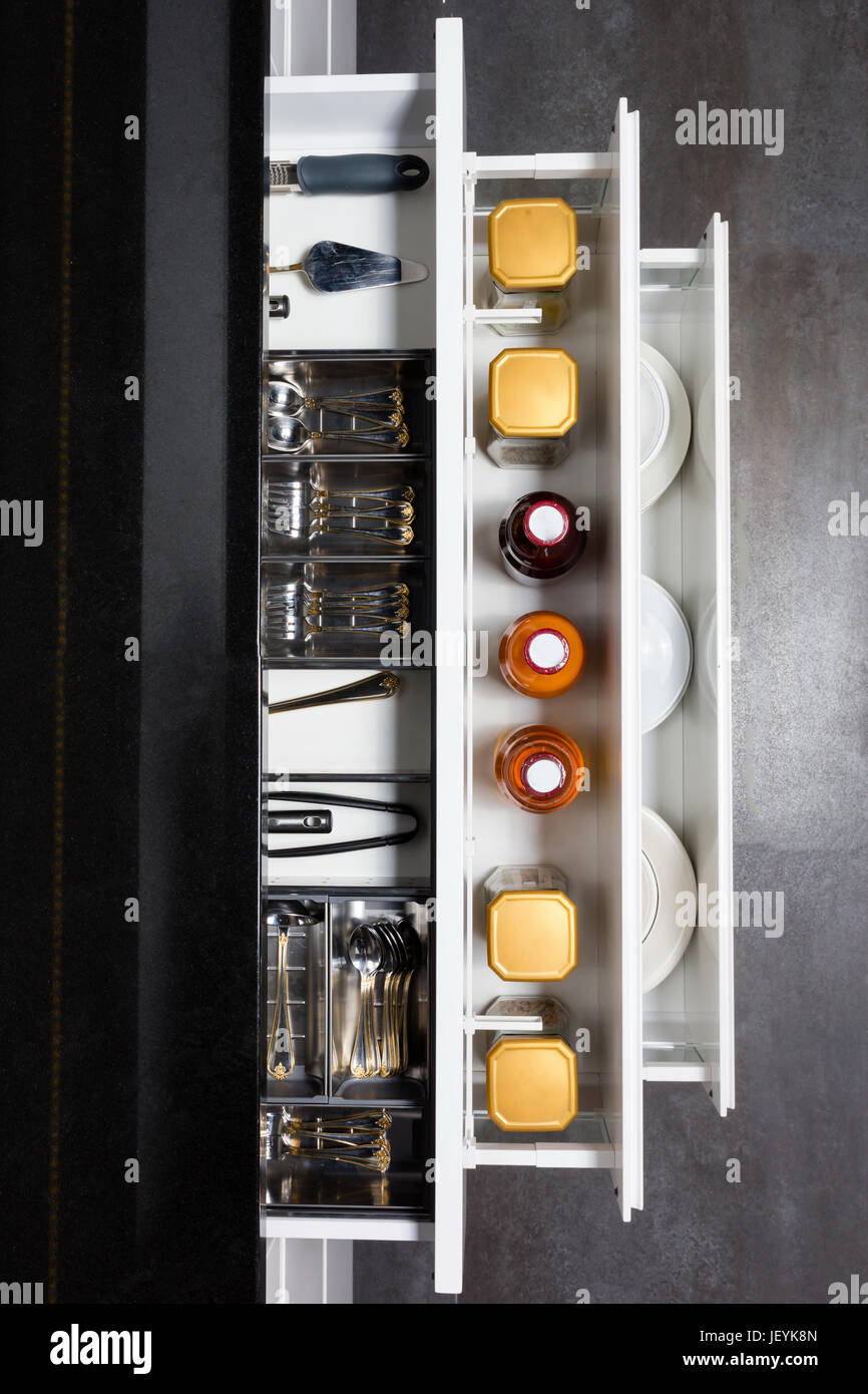 Modern kitchen countertop with food ingredients. Top view of drawers ...