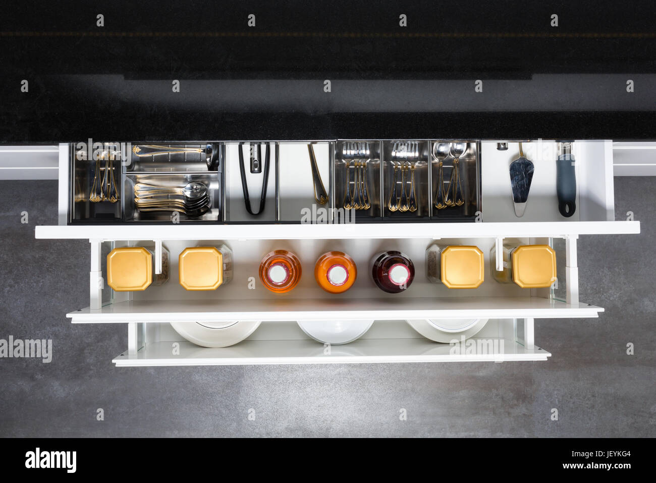 Modern kitchen countertop with food ingredients. Top view of drawers ...