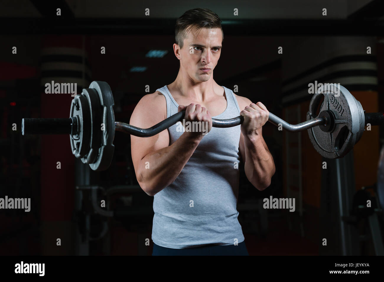Closeup Portrait Of A Muscular Man Workout With Barbell At Gym