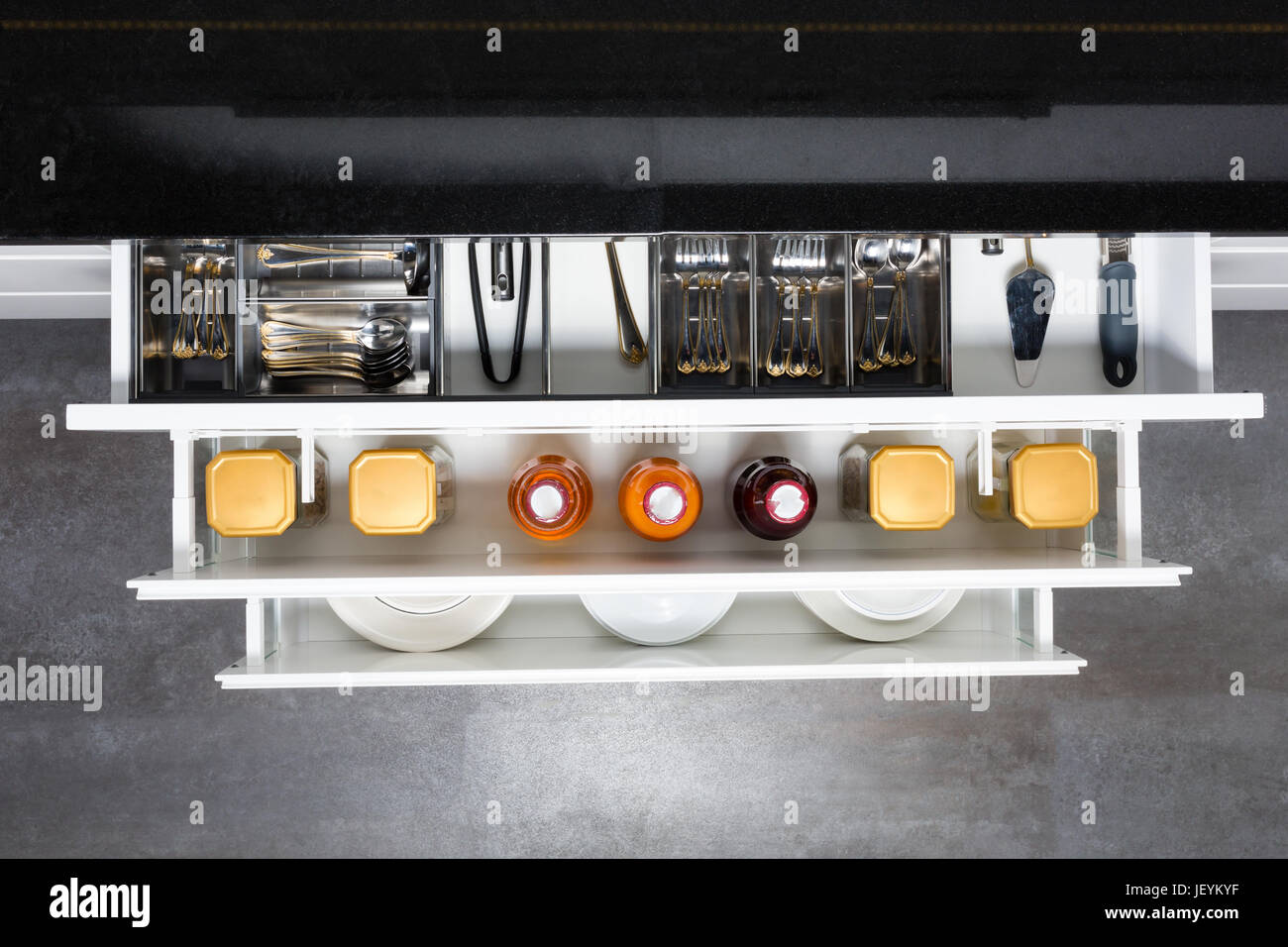 Modern kitchen countertop with food ingredients. Top view of drawers ...