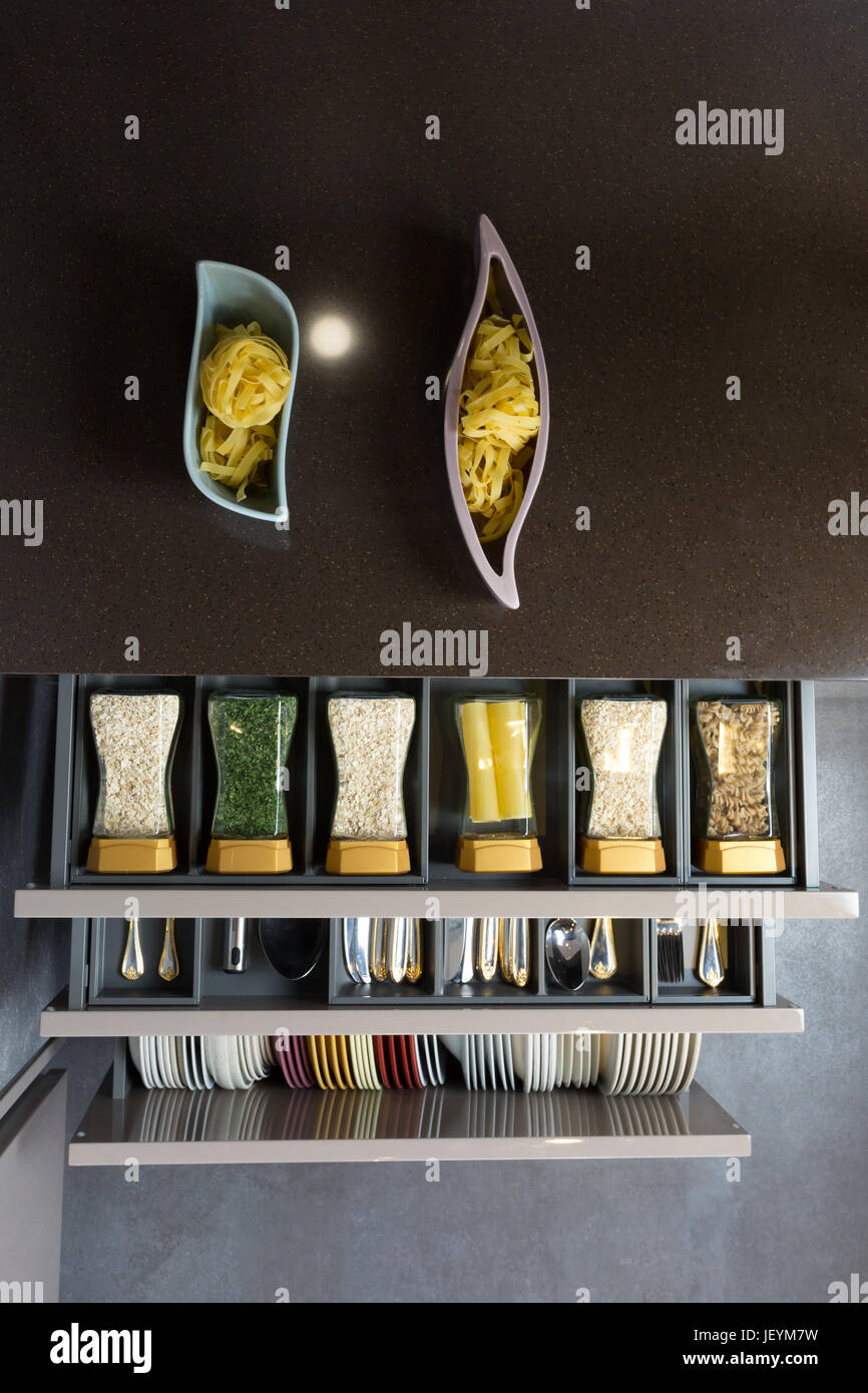 Modern kitchen countertop with food ingredients. Top view of drawers ...
