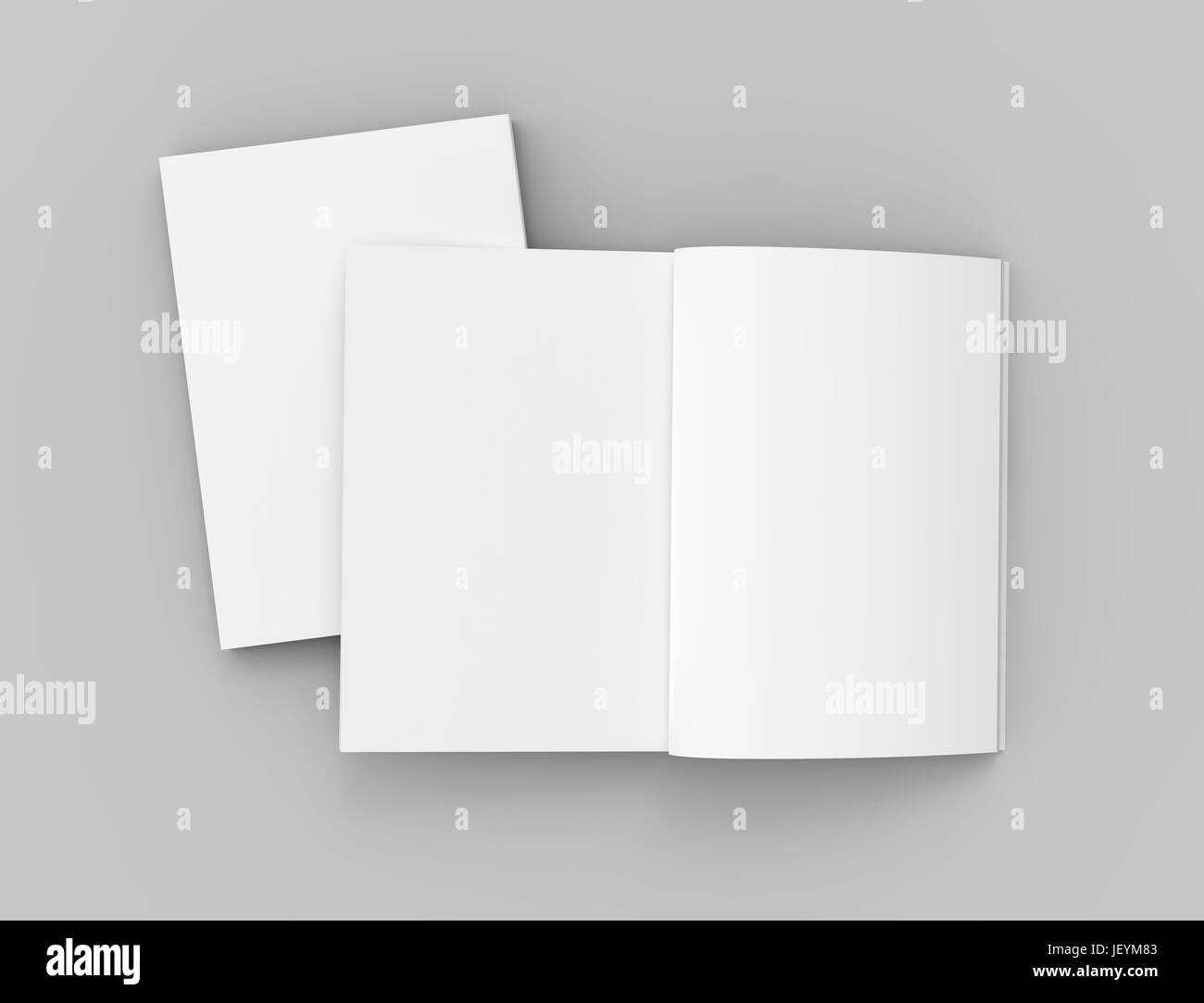 two stacking blank books on the ground, one right tilt and one open ...