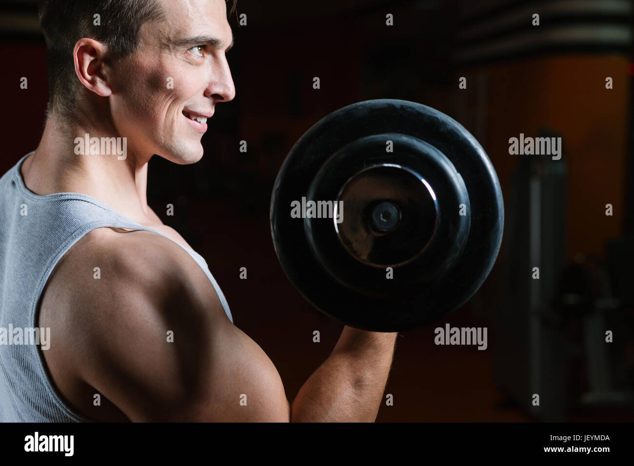 Closeup Portrait Of A Muscular Man Workout With Barbell At Gym