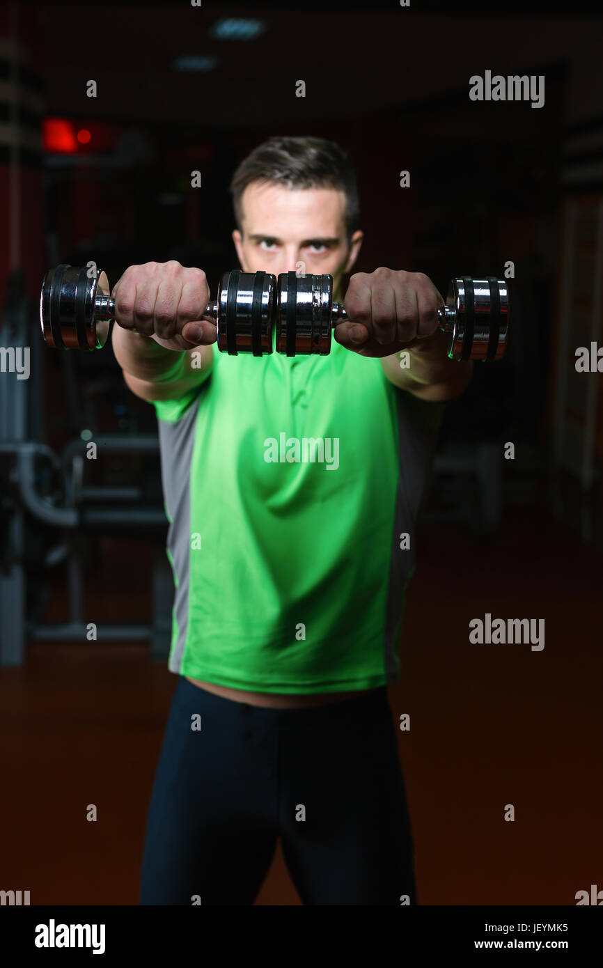 Closeup Portrait Of A Muscular Man Workout With Barbell At Gym