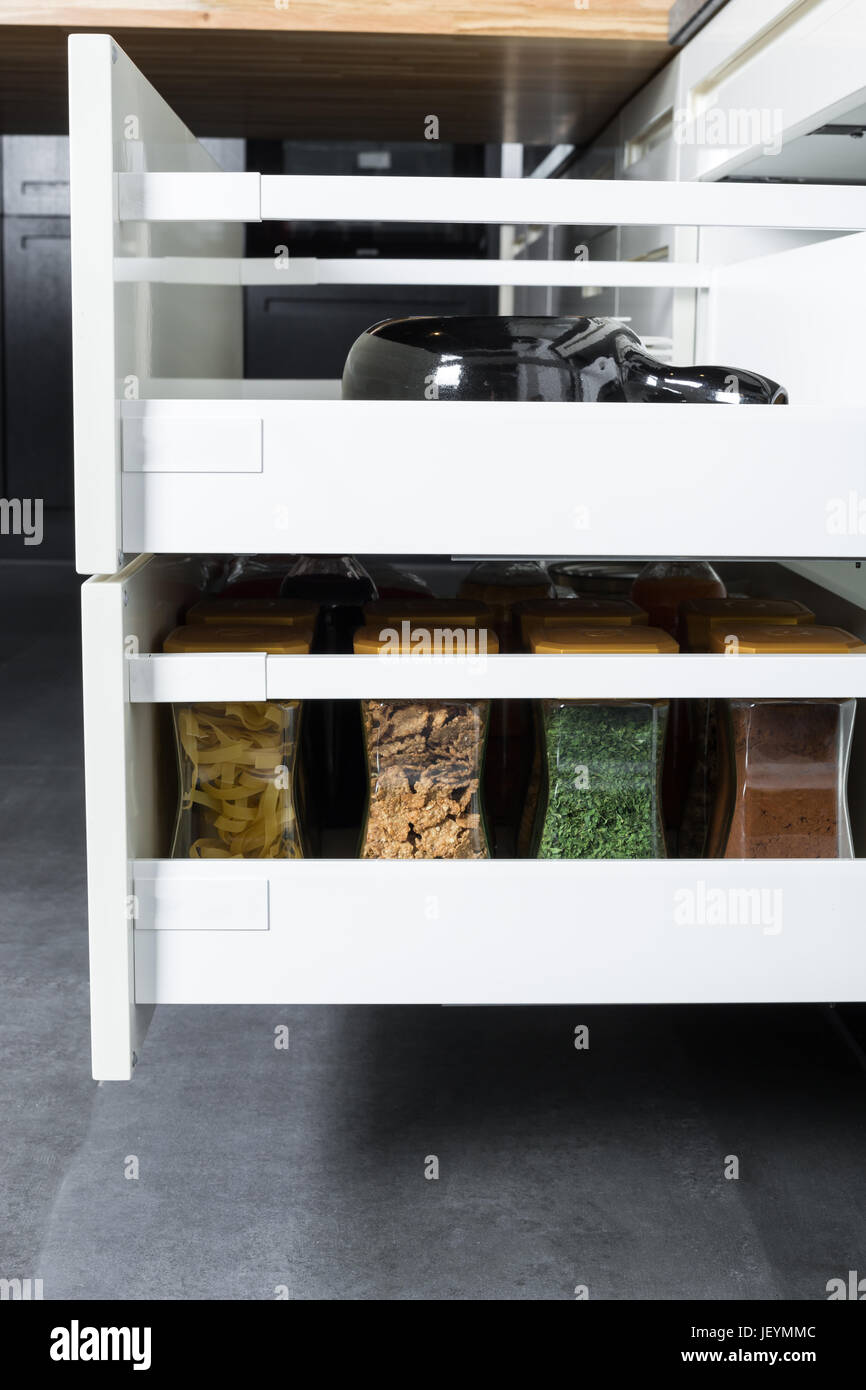 Side view of a spices and groceries organized in a modern kitchen ...
