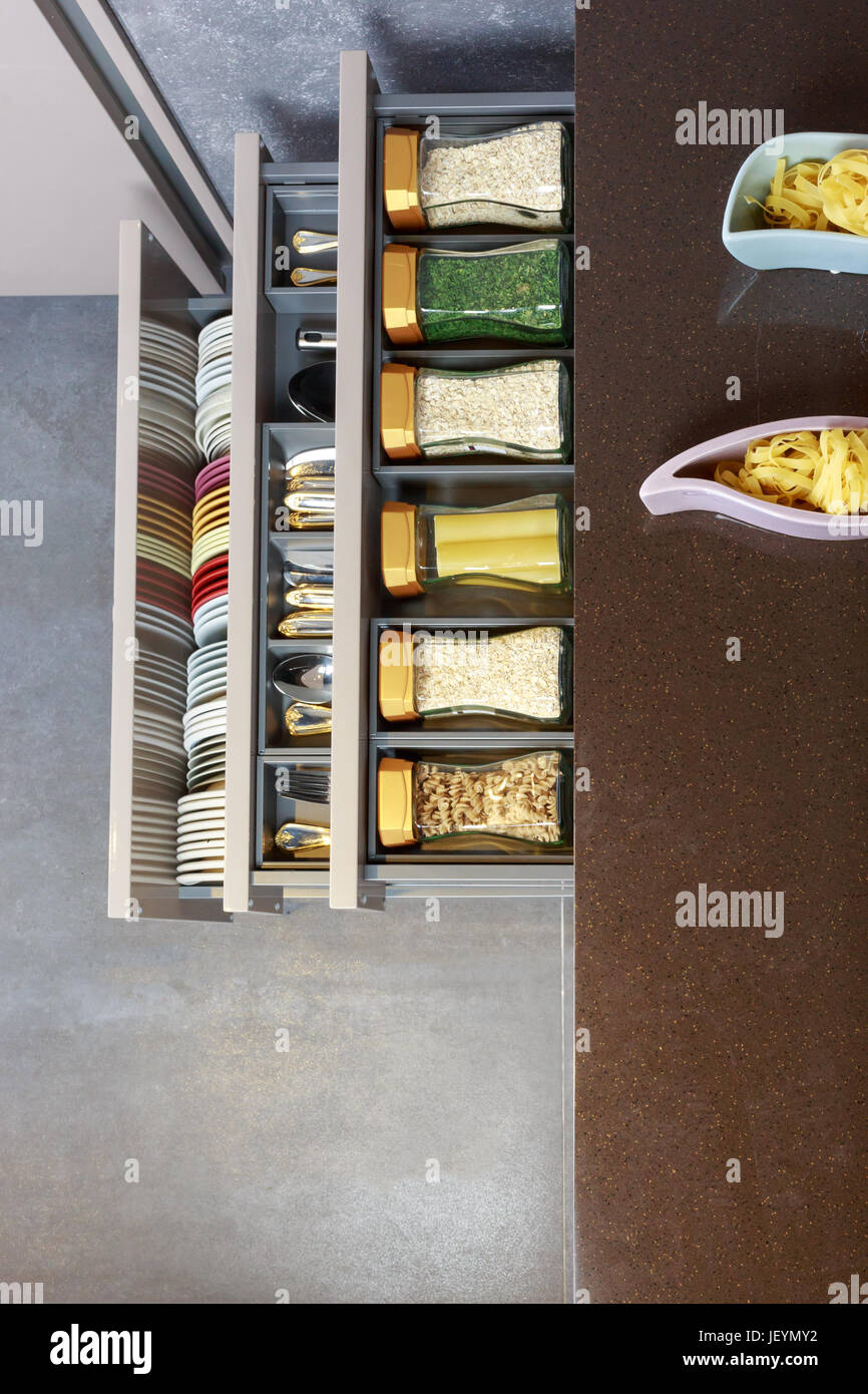 Modern kitchen countertop with food ingredients. Top view of drawers ...