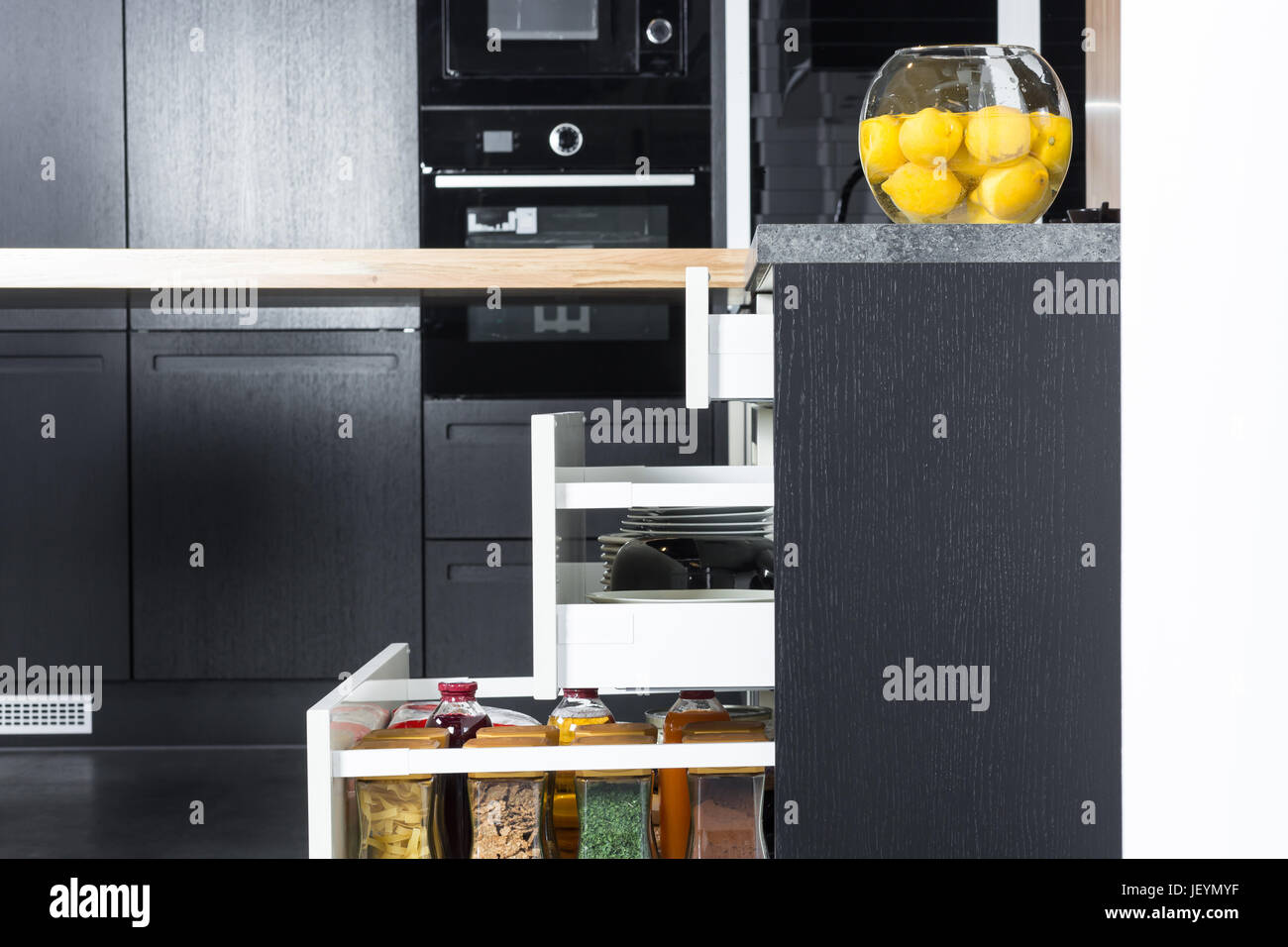 Side view of a spices and groceries organized in a modern kitchen ...
