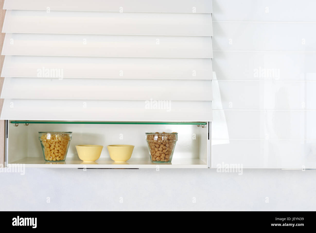 Food ingredients organized on a shelf on modern kitchen countertop ...