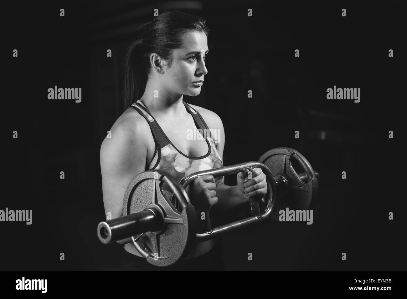 Beautiful muscular bodybuilder woman with weights Stock Photo - Alamy