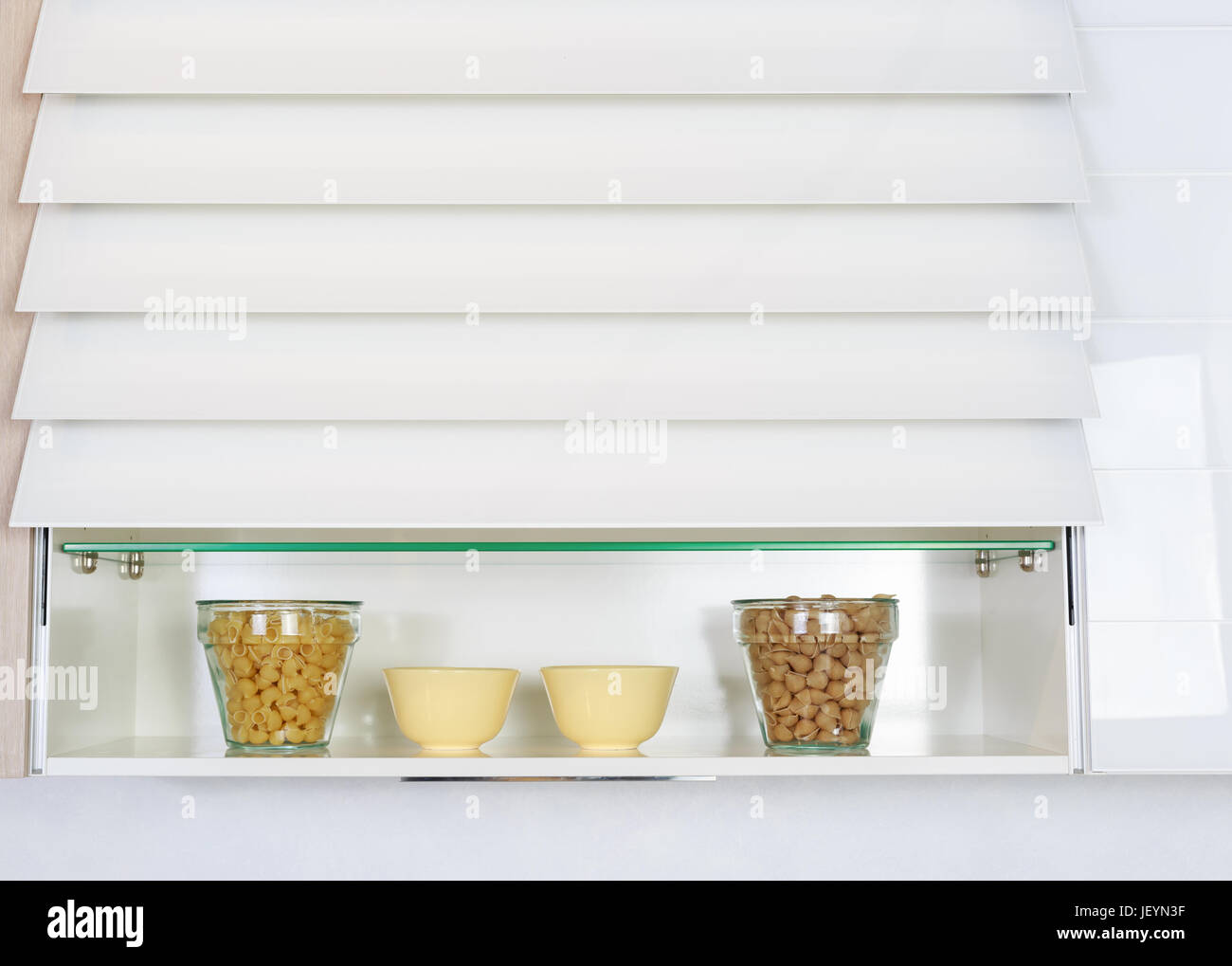 Food ingredients organized on a shelf on modern kitchen countertop ...