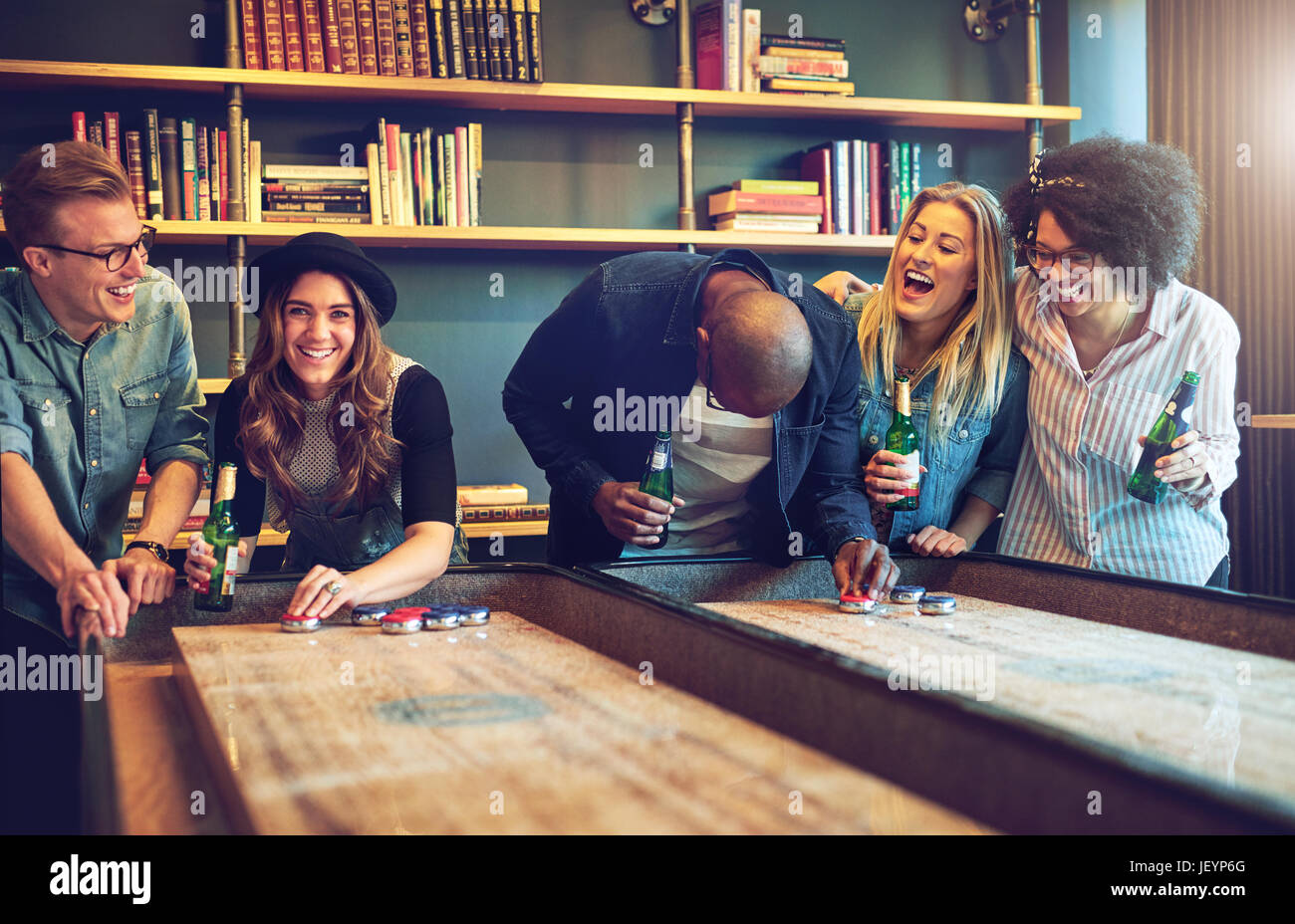 Group of friends having fun playing a game. Mixed races as friends ...