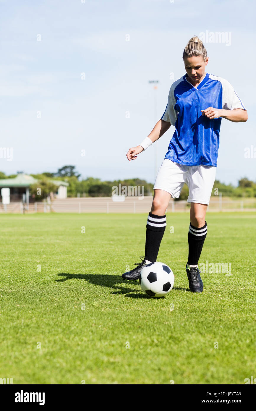 Female football player practicing soccer Stock Photo - Alamy