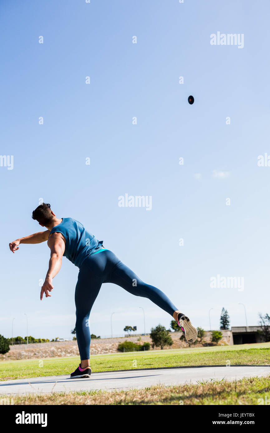 Athlete throwing discus in stadium Stock Photo - Alamy