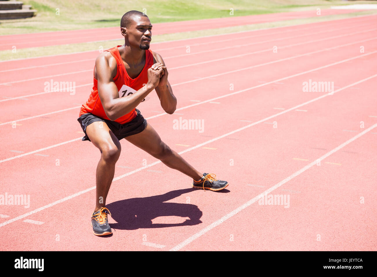 Athlete warming up on the running track Stock Photo - Alamy
