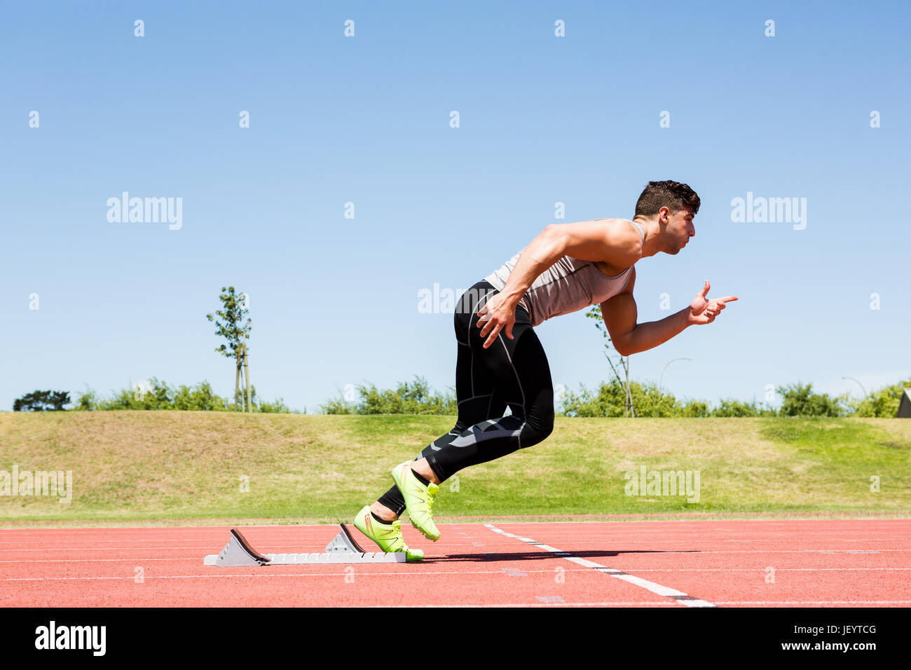 Athlete running on the running track Stock Photo - Alamy