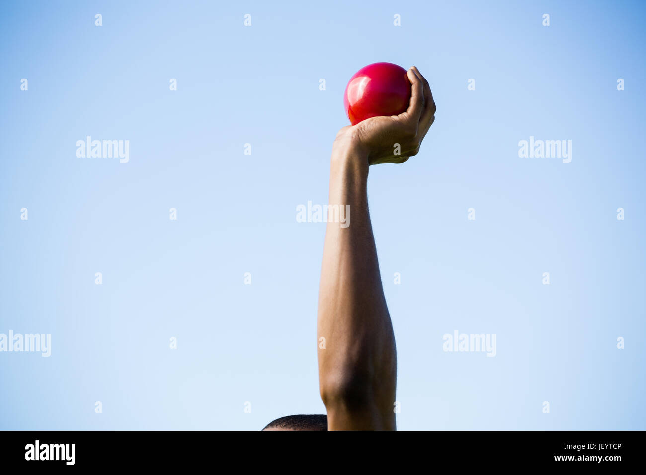 Athletes hand performing shot put Stock Photo - Alamy