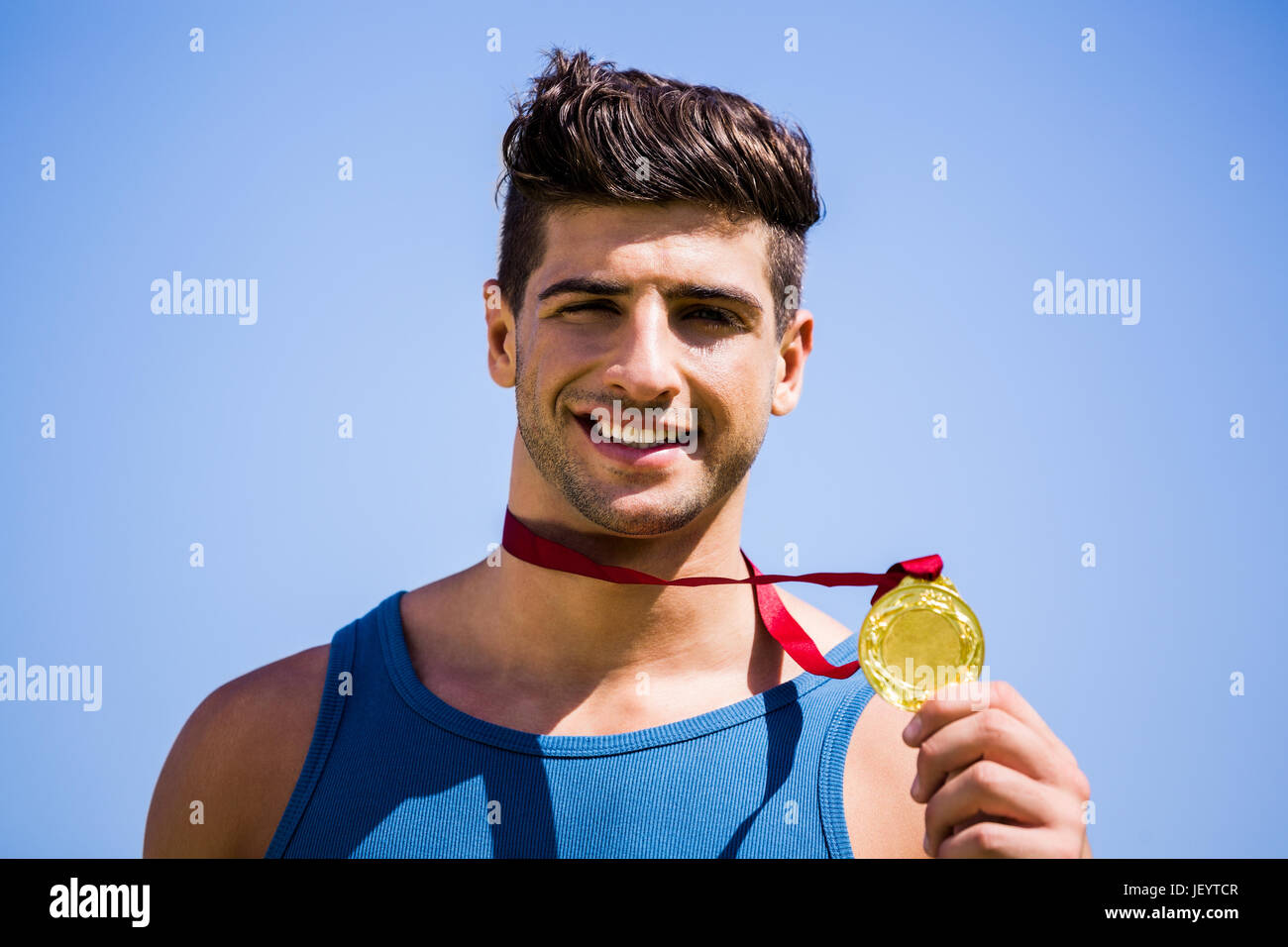 Athlete showing his gold medal Stock Photo - Alamy