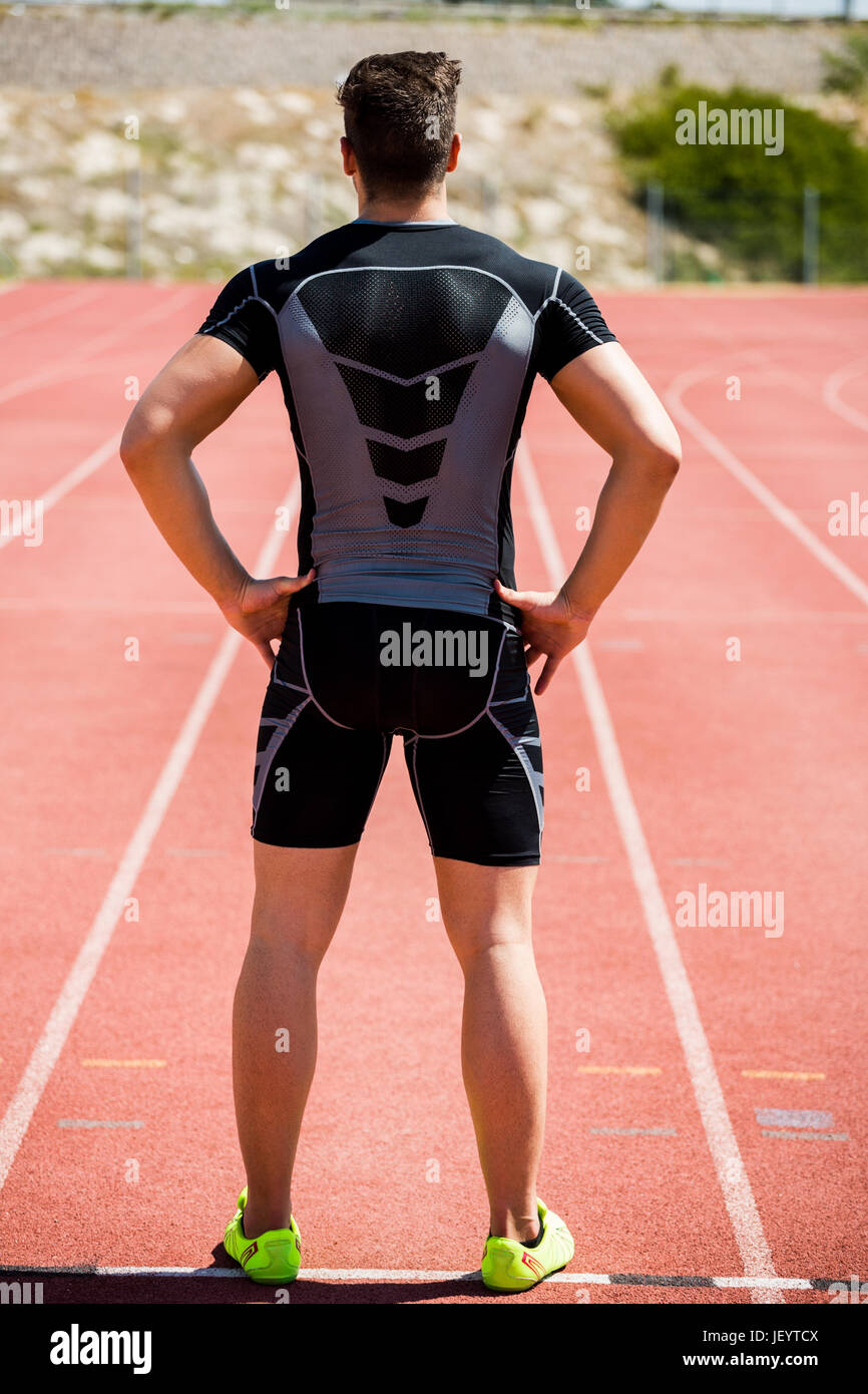 Athlete standing on running track Stock Photo - Alamy