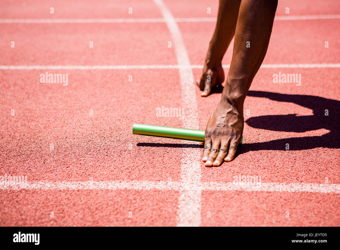Hands of athlete holding baton Stock Photo - Alamy