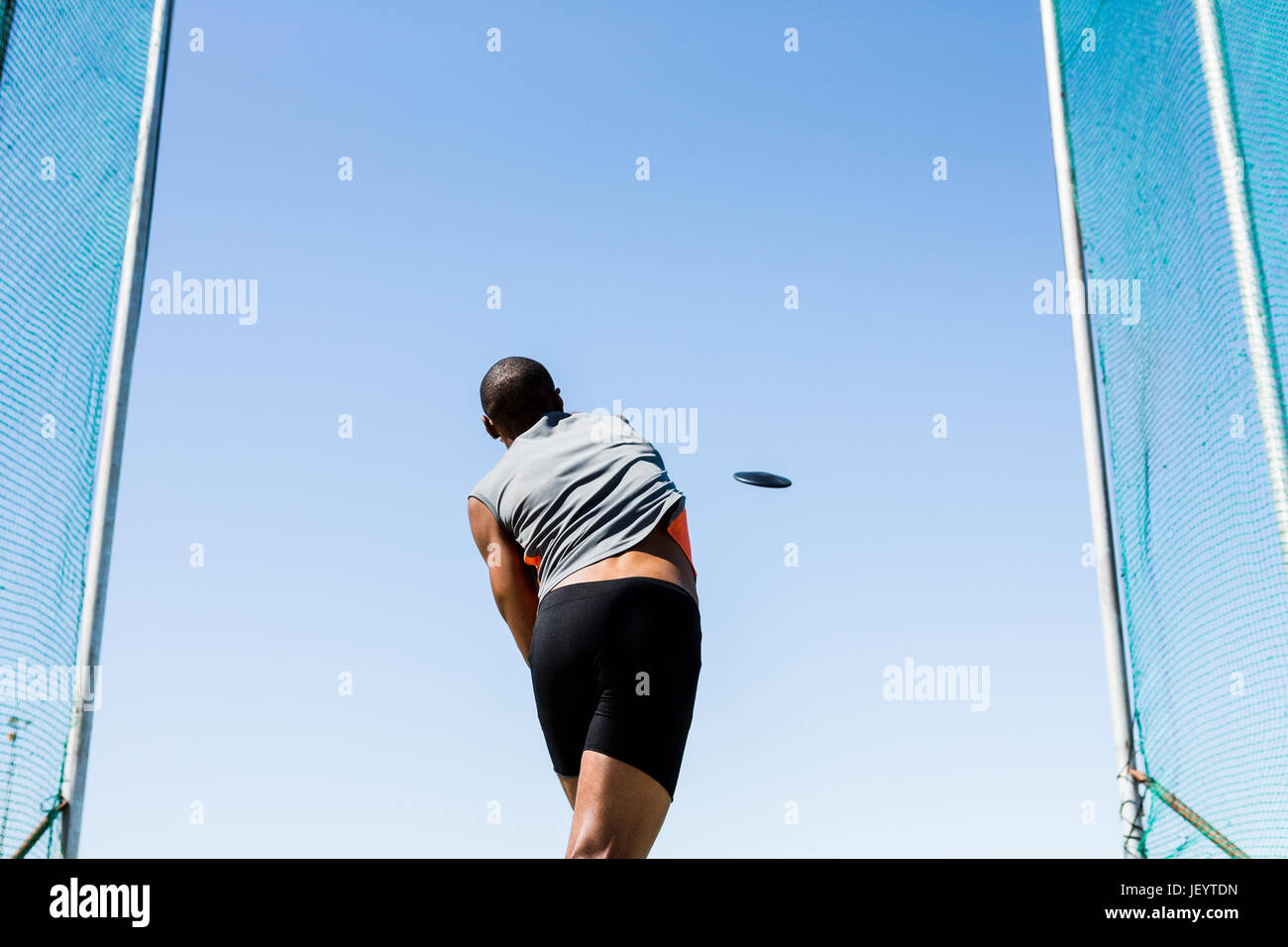Athlete throwing discus in stadium Stock Photo - Alamy