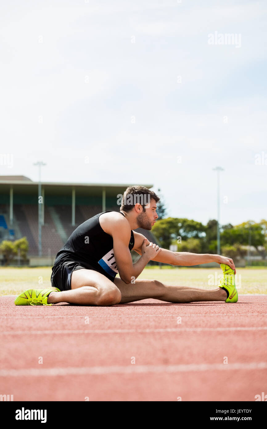 Athlete doing stretching exercise Stock Photo - Alamy