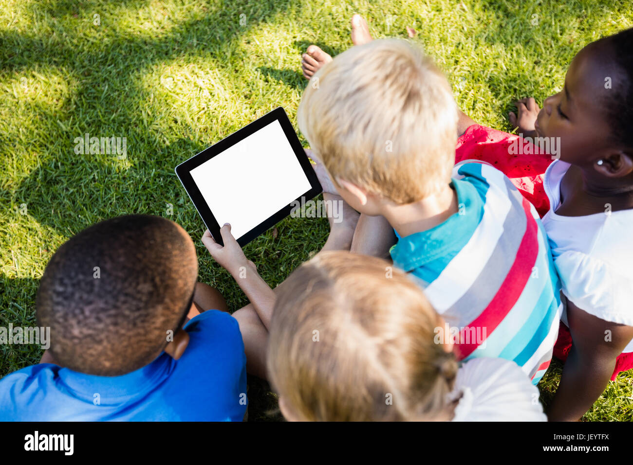 Kids using technology during a sunny day Stock Photo - Alamy