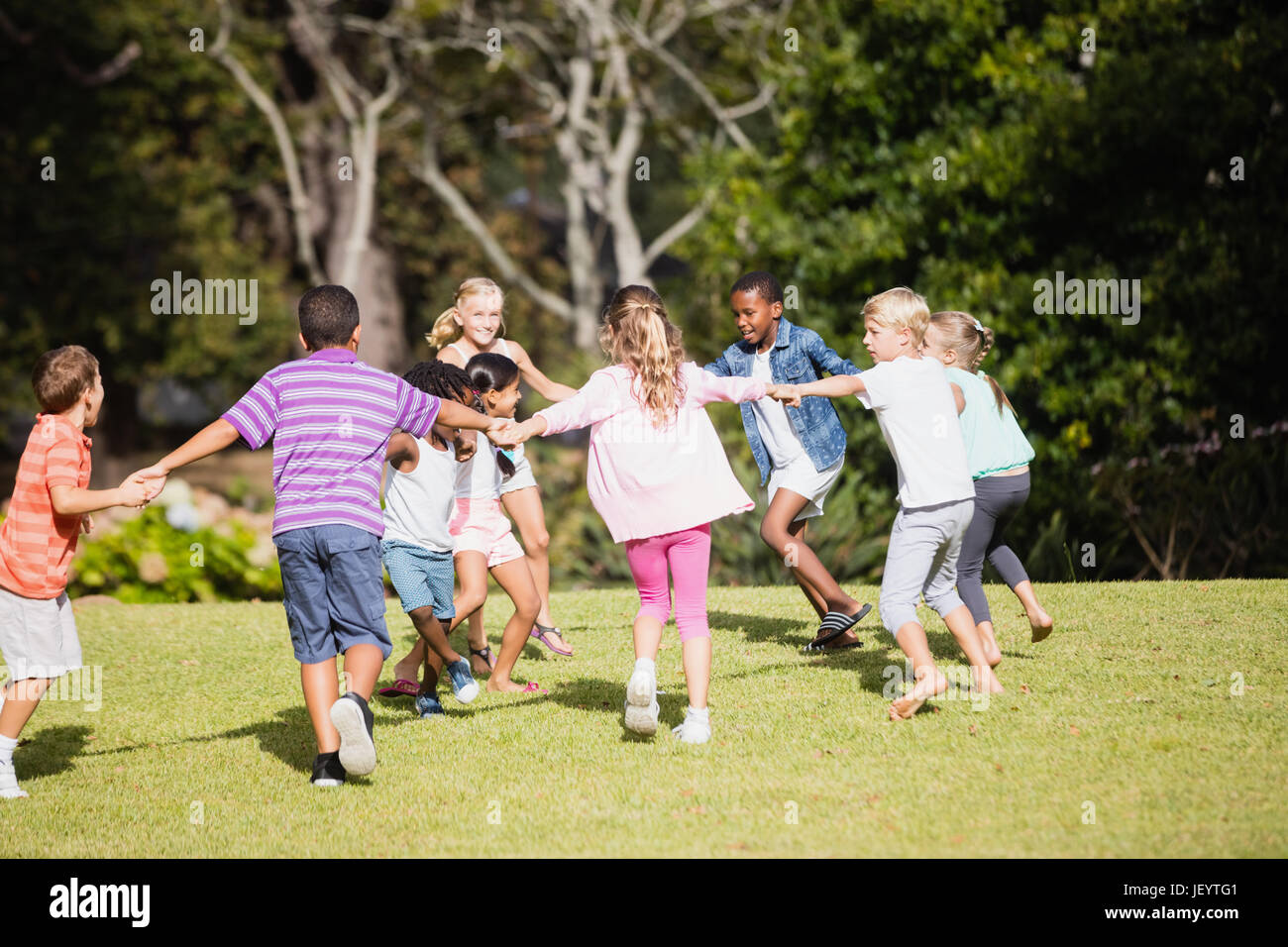 Kids playing together during a sunny day Stock Photo - Alamy