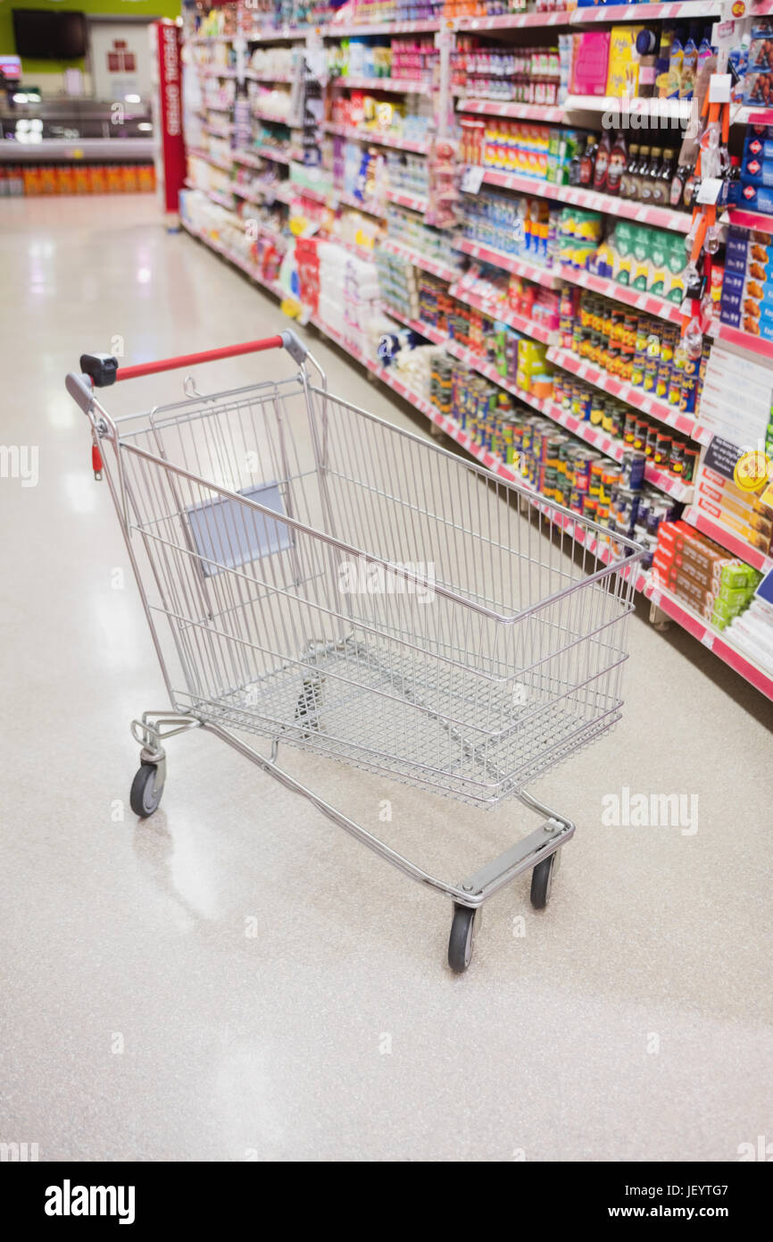 Empty trolley in an aisle Stock Photo - Alamy