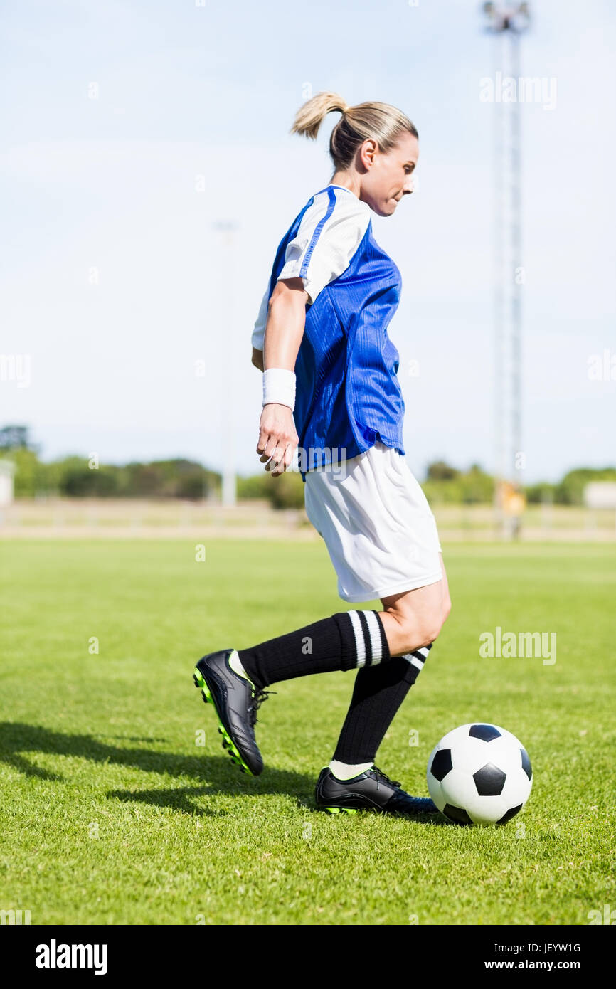 Female football player practicing soccer Stock Photo - Alamy