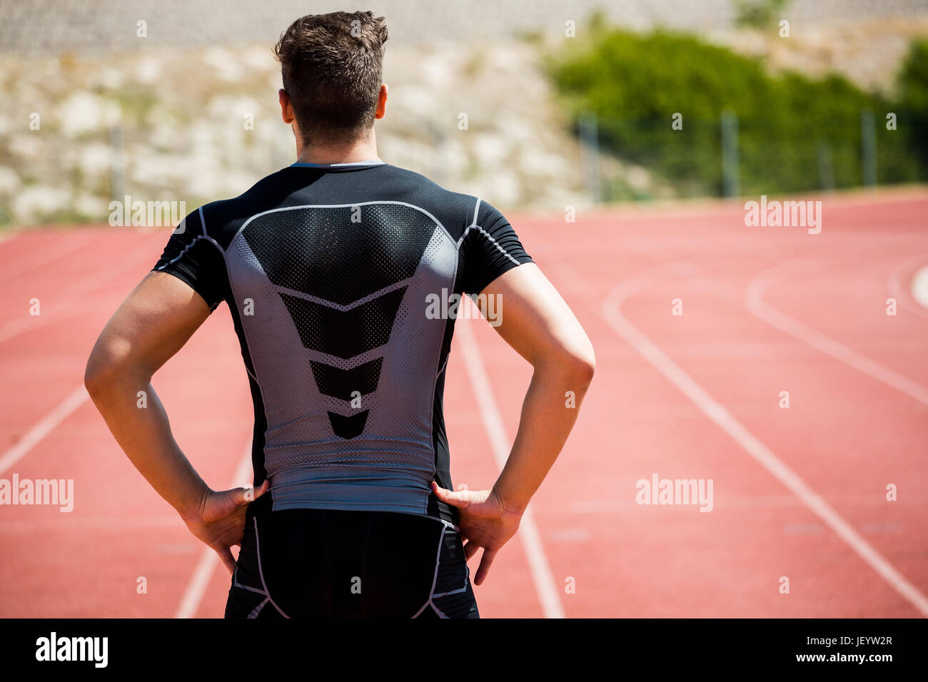 Athlete standing on running track Stock Photo - Alamy