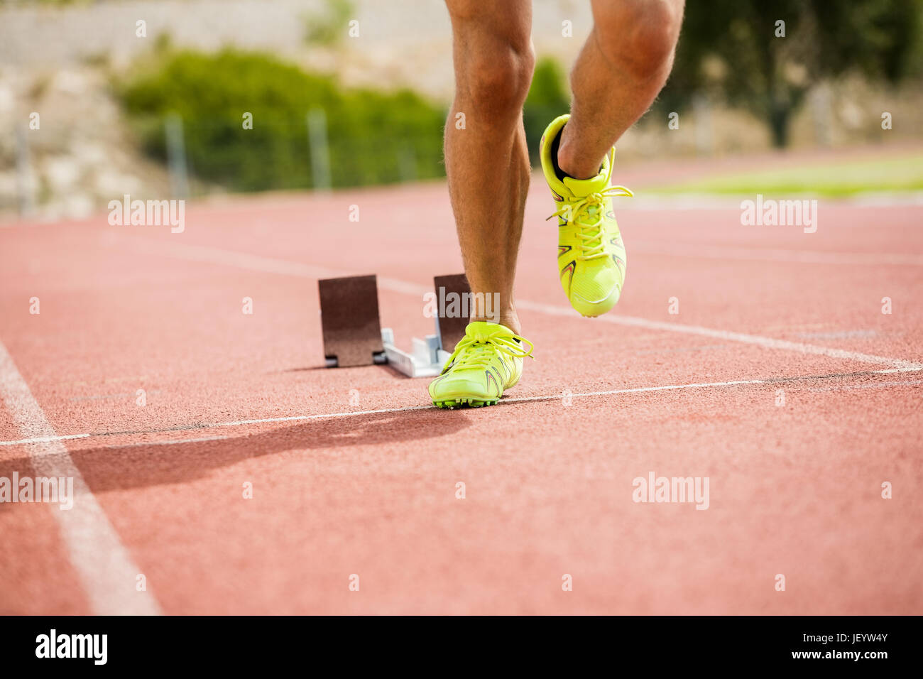 Athlete running on the racing track Stock Photo - Alamy