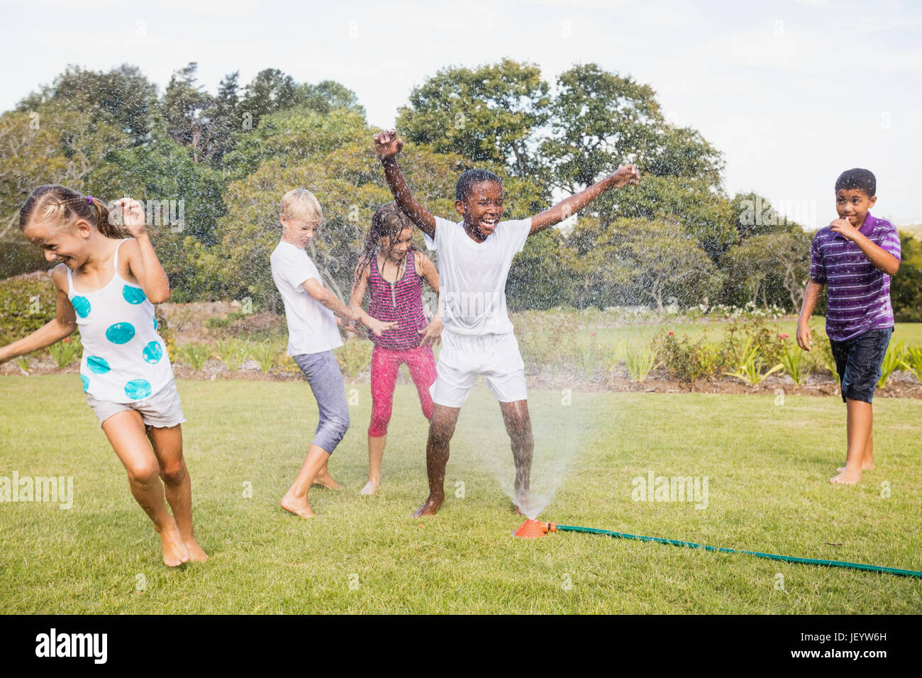 Kids playing together during a sunny day Stock Photo - Alamy
