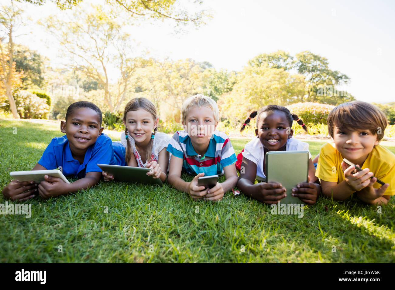 Kids using technology during a sunny day Stock Photo - Alamy