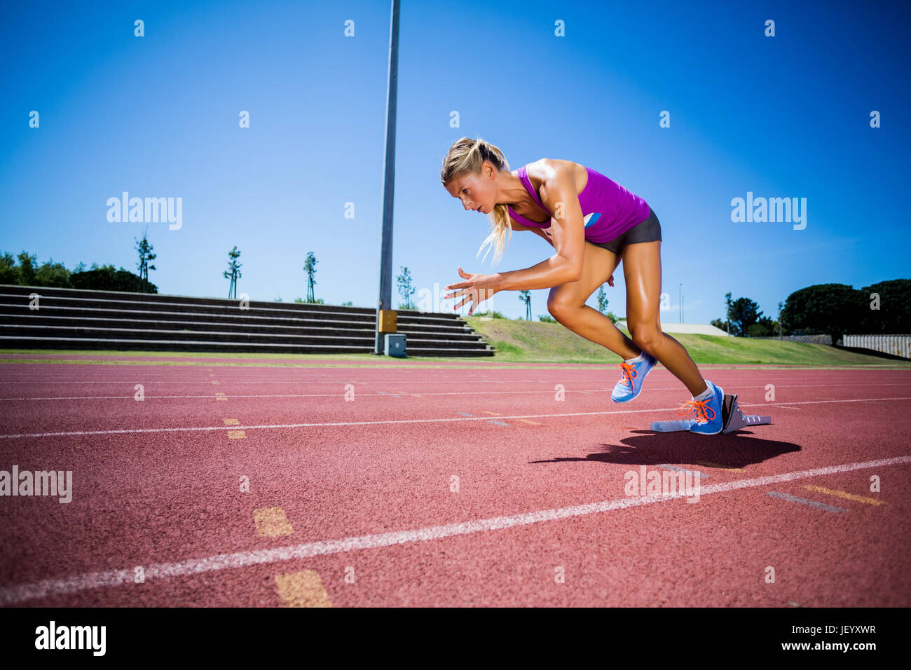 Female athlete running on the racing track Stock Photo - Alamy