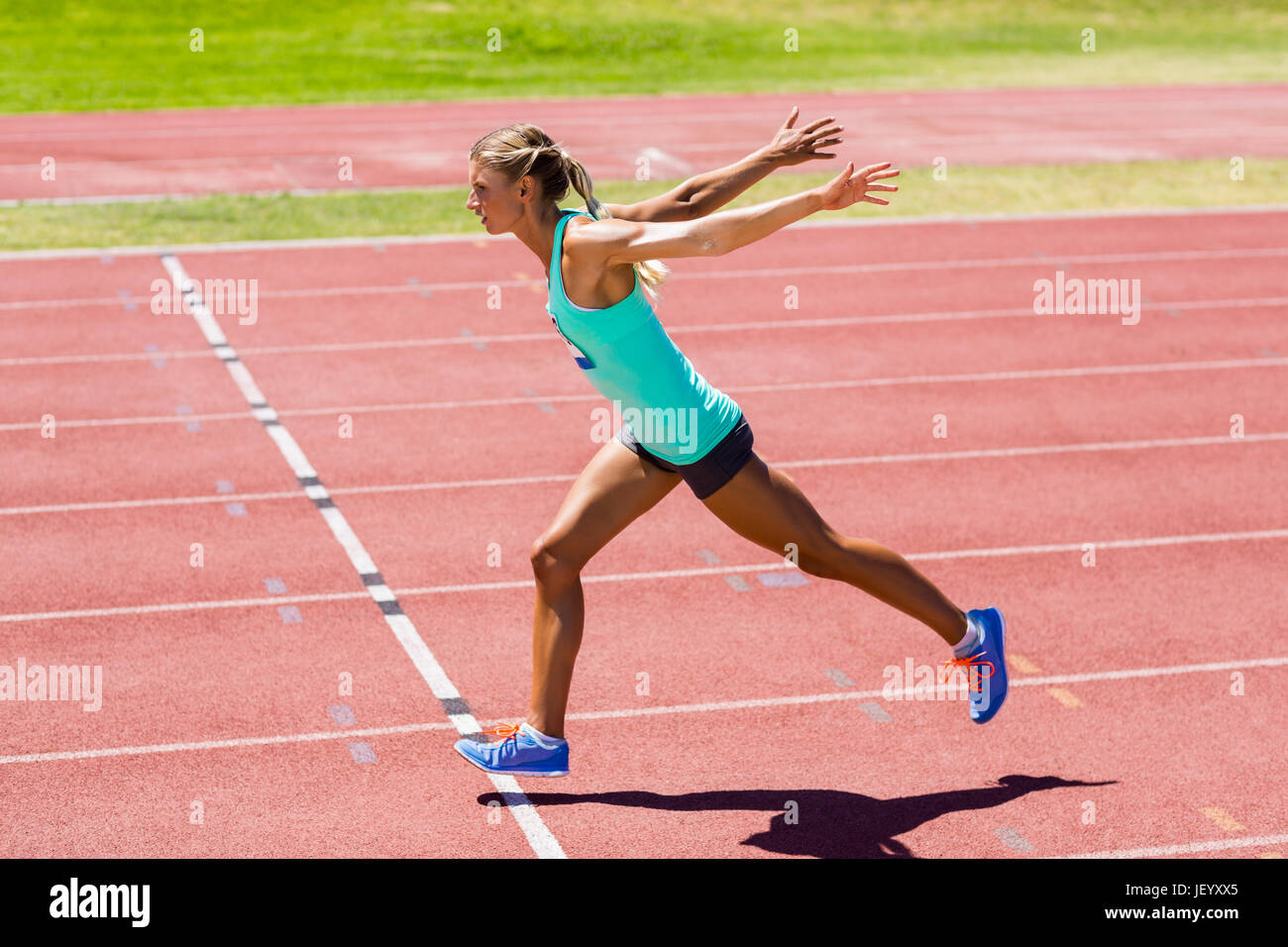 Female athlete running on the racing track Stock Photo - Alamy