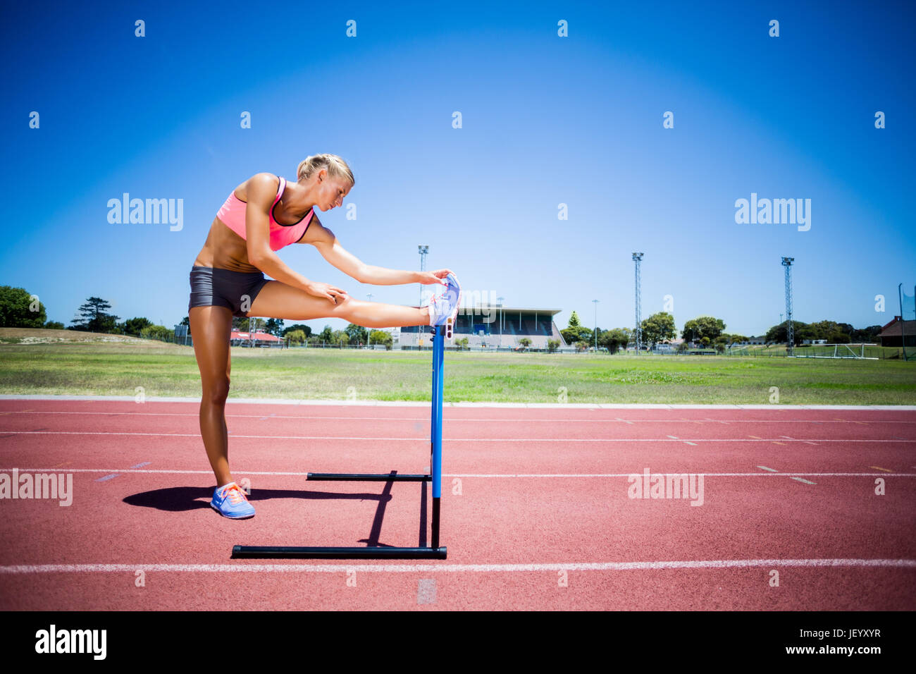 Female athlete warming up on running track Stock Photo - Alamy