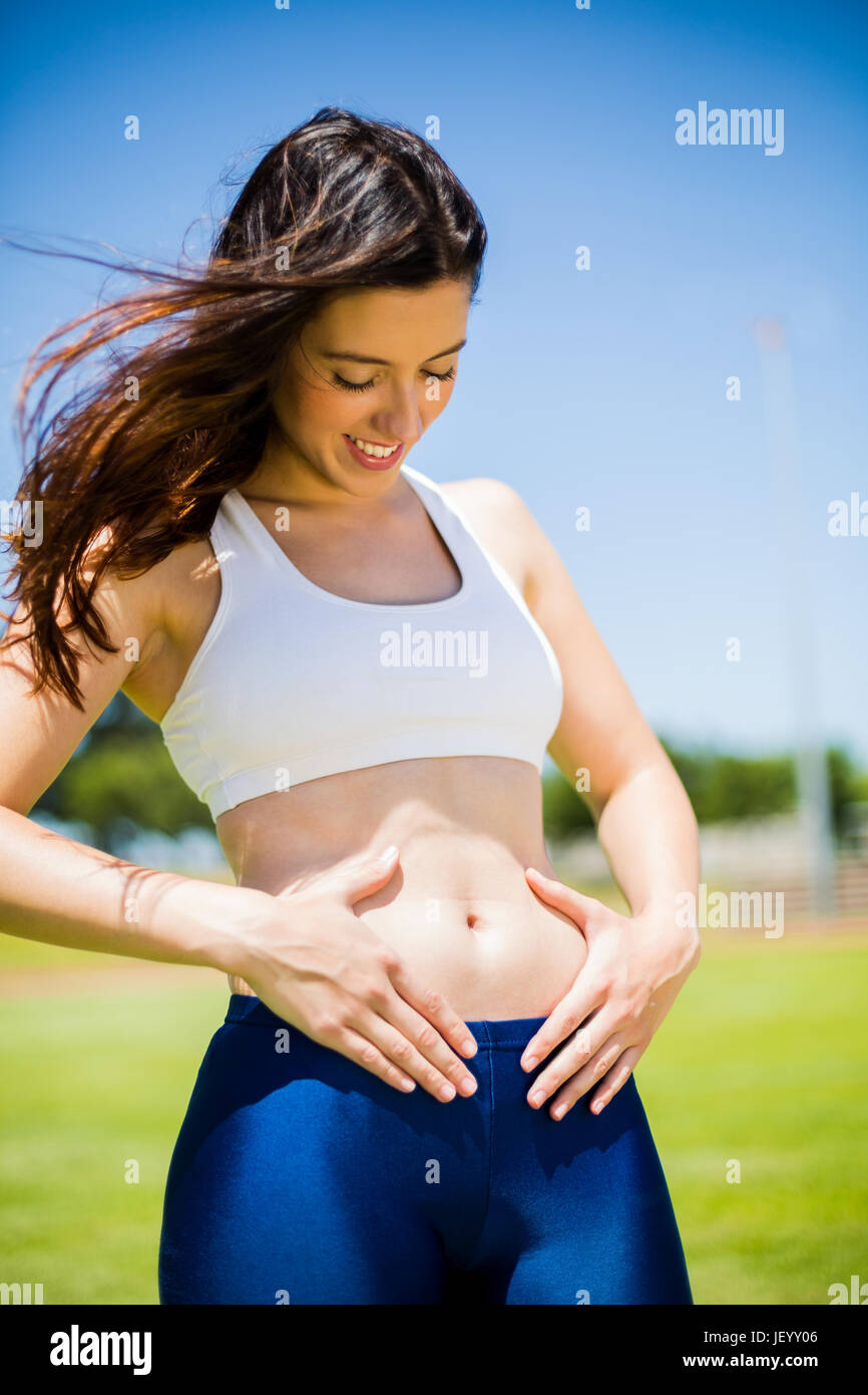 Beautiful woman touching her belly Stock Photo - Alamy
