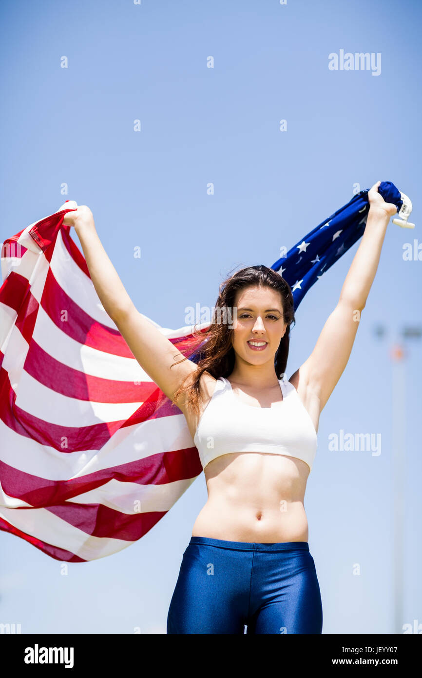 Female athlete holding an american flag Stock Photo - Alamy
