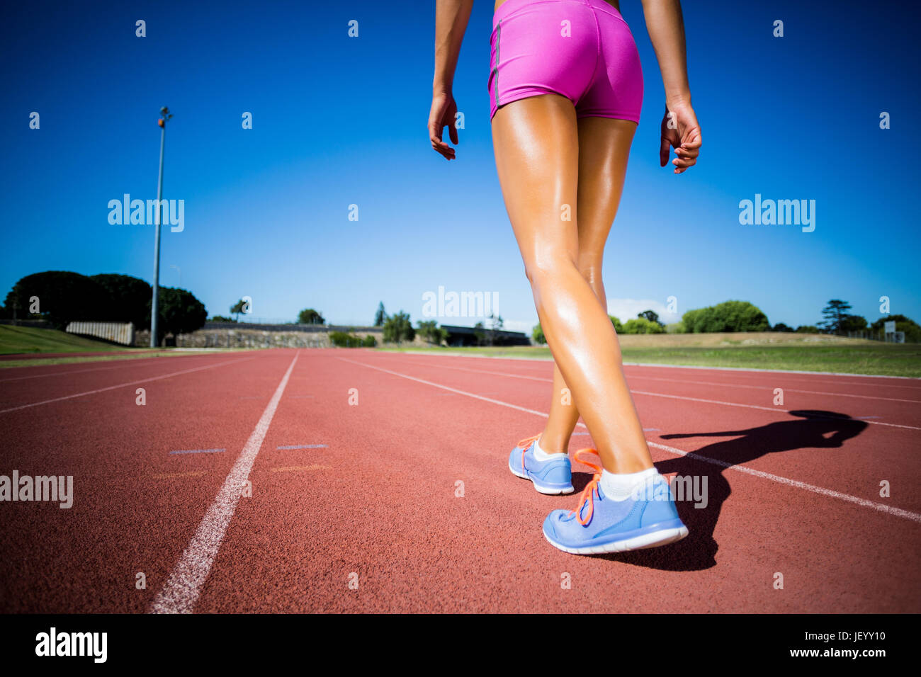 Female athlete walking on the racing track Stock Photo - Alamy