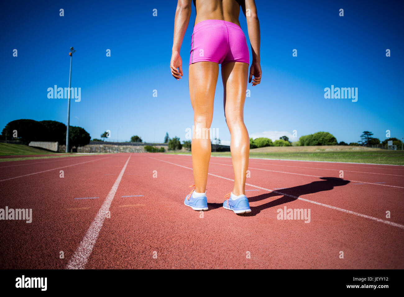 Female athlete standing on the running track Stock Photo - Alamy