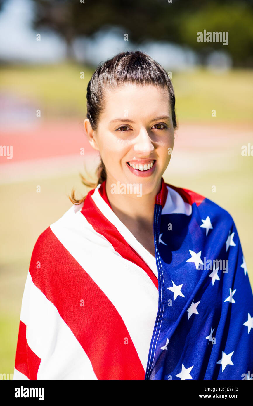 Female athlete wrapped in american flag Stock Photo - Alamy