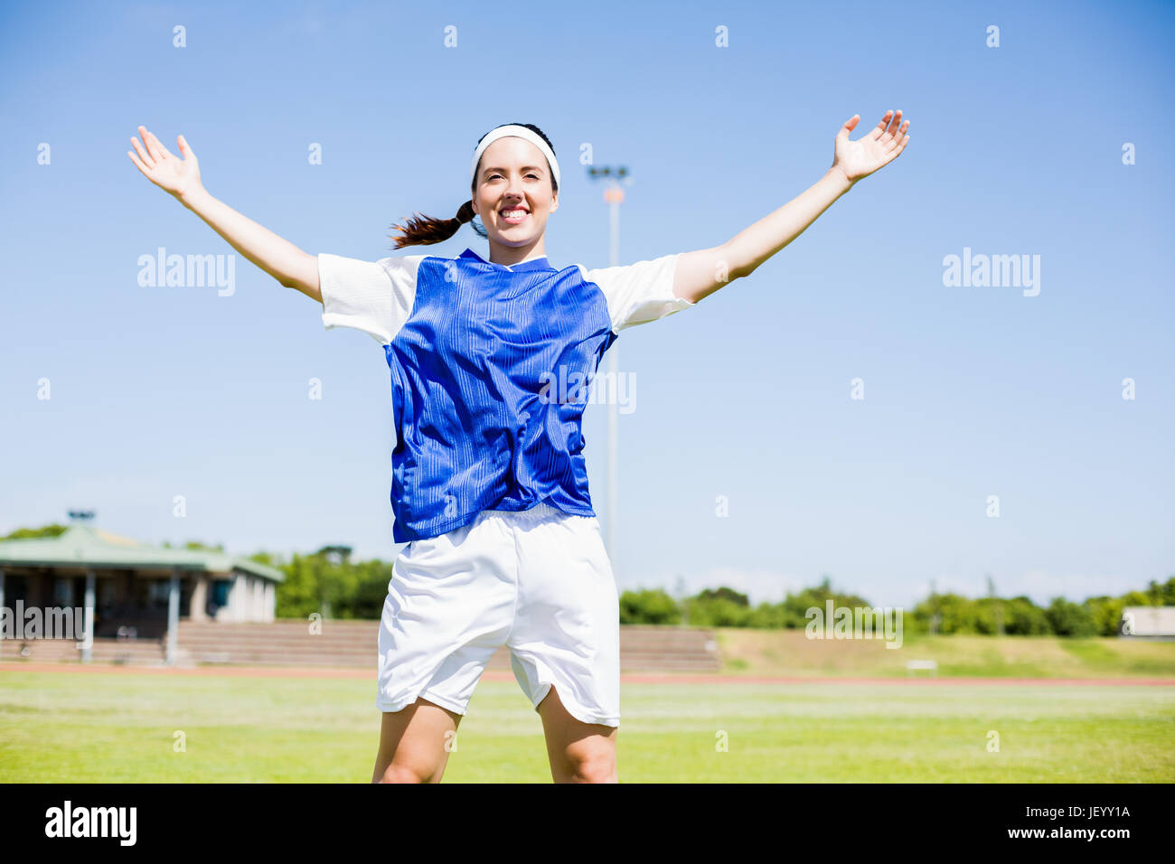 Happy soccer player posing after victory Stock Photo - Alamy