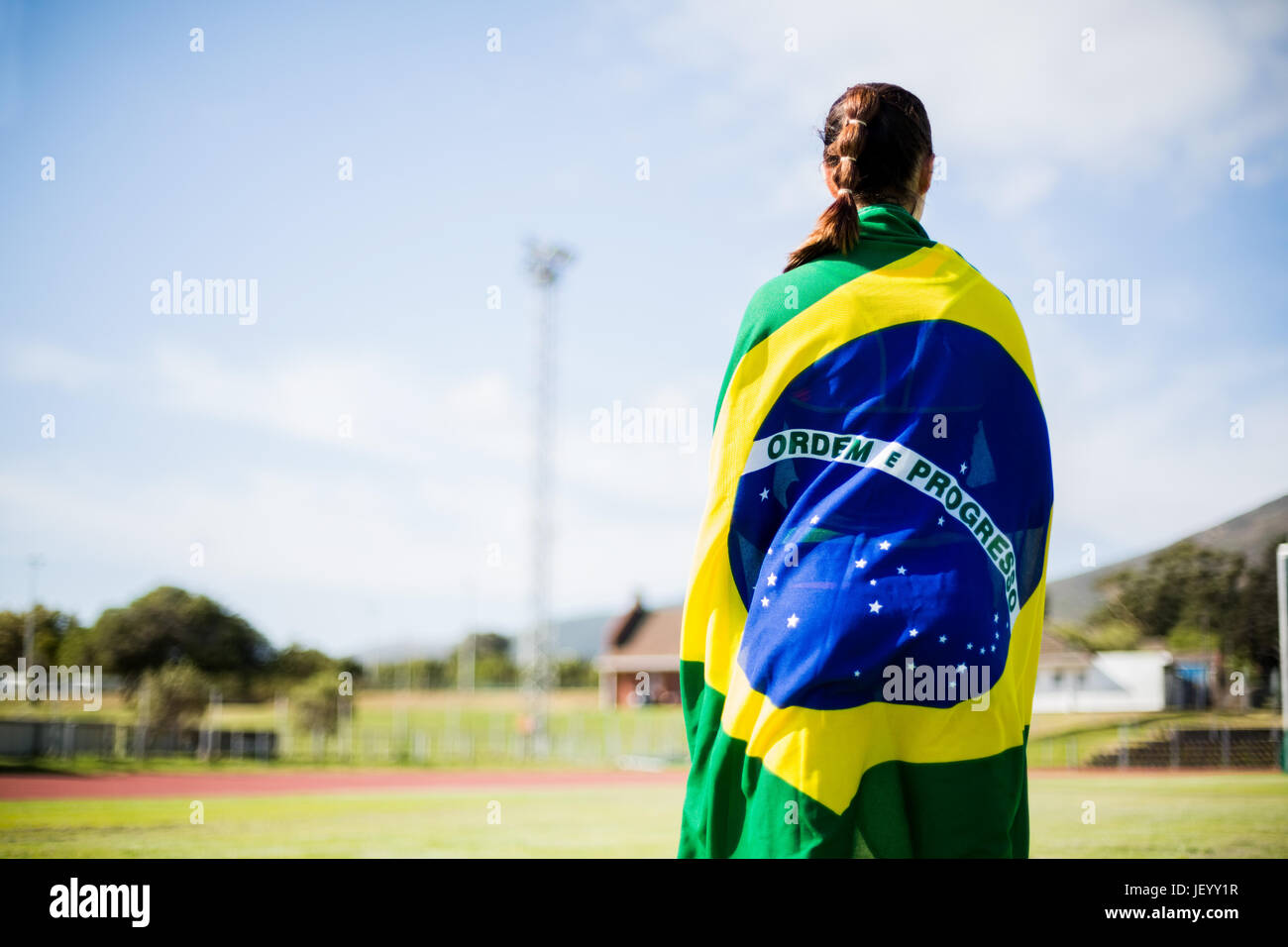 Female athlete wrapped in Brazilian flag Stock Photo - Alamy