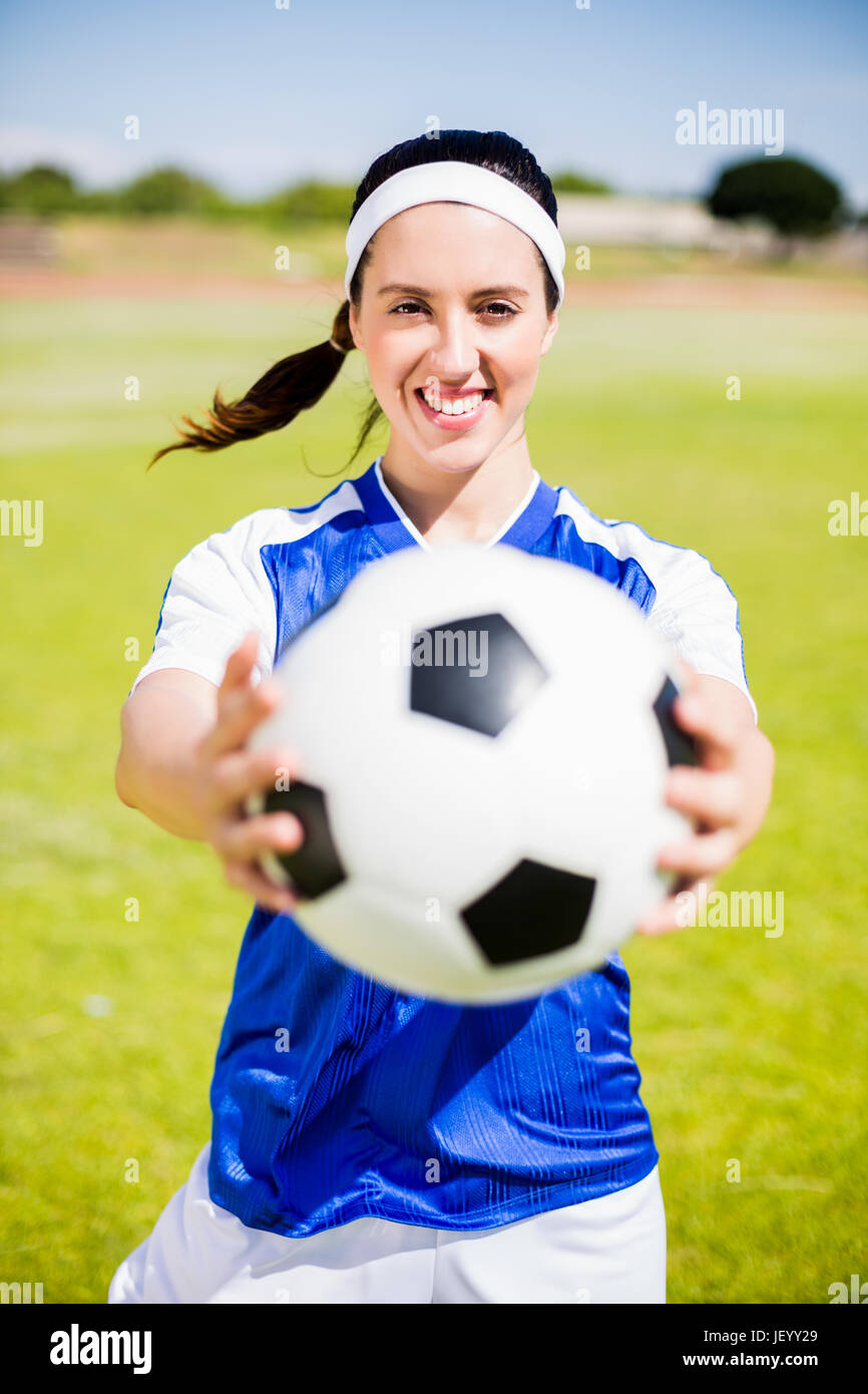 Happy soccer player standing with a ball Stock Photo - Alamy