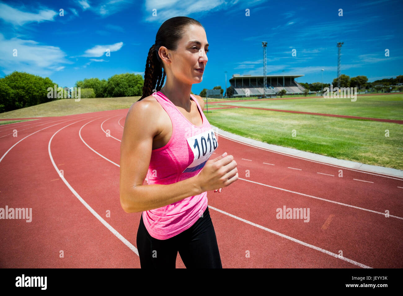 Female athlete running on the running track Stock Photo - Alamy