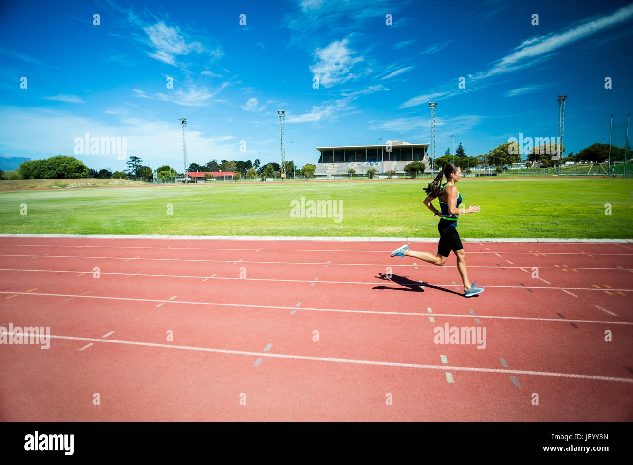 Female athlete running on the running track Stock Photo - Alamy