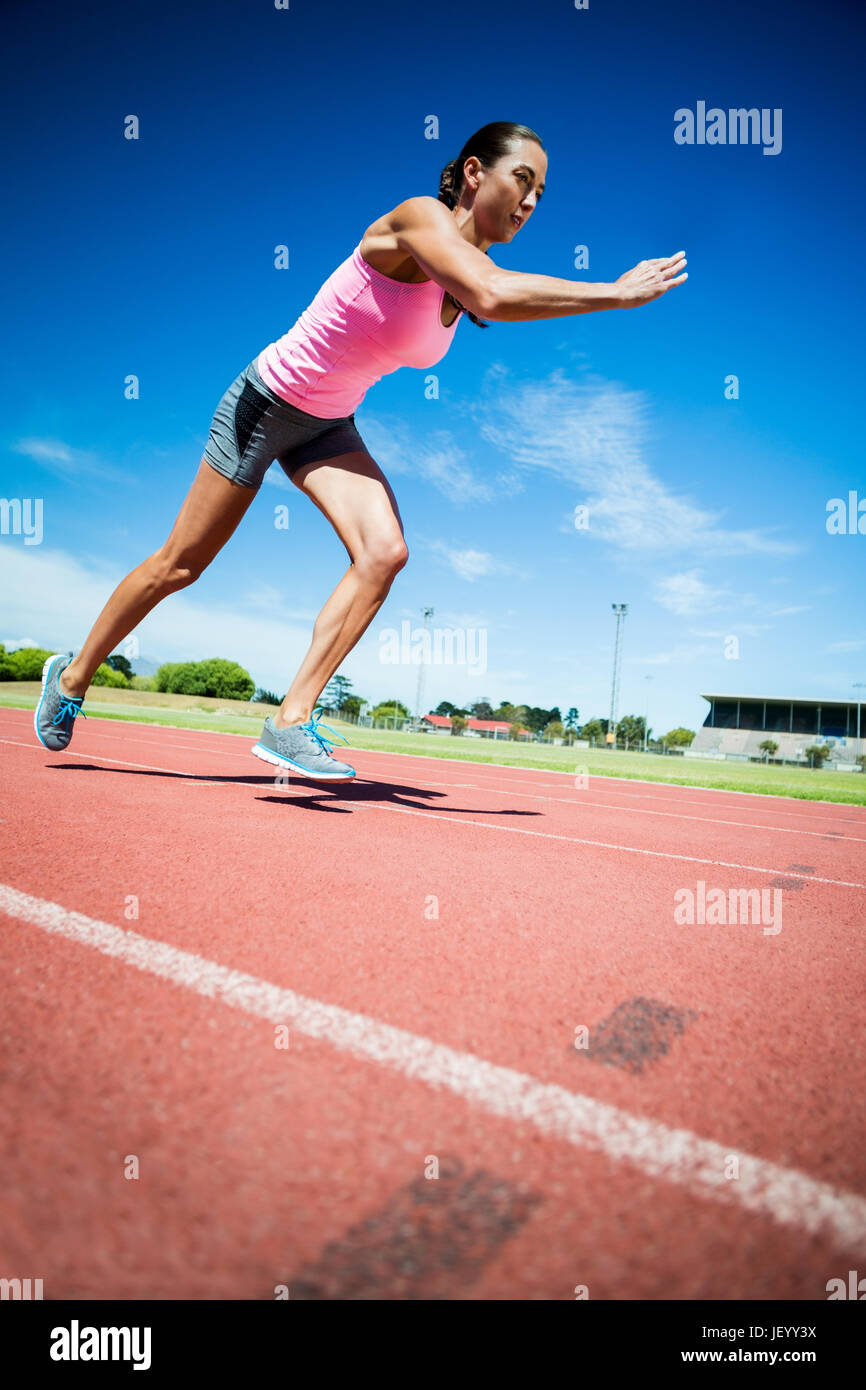 Female athlete running on the running track Stock Photo - Alamy
