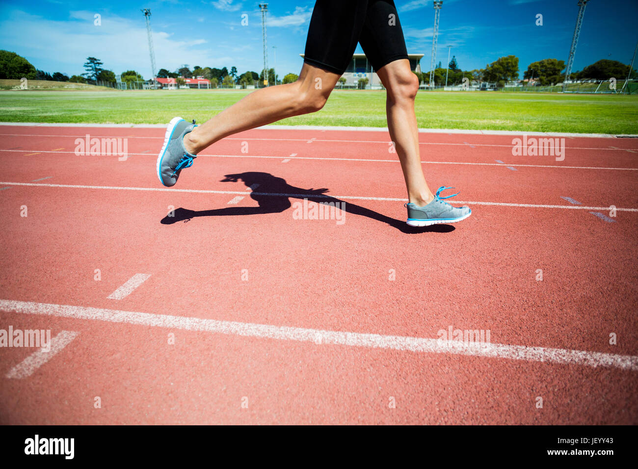 Female athlete running on the running track Stock Photo - Alamy