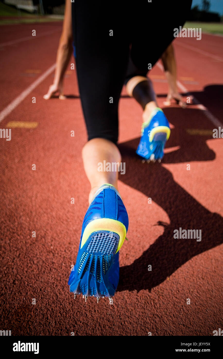 Female athlete in ready to run position Stock Photo - Alamy