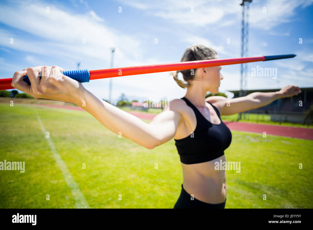 Female athlete about to throw a javelin Stock Photo - Alamy